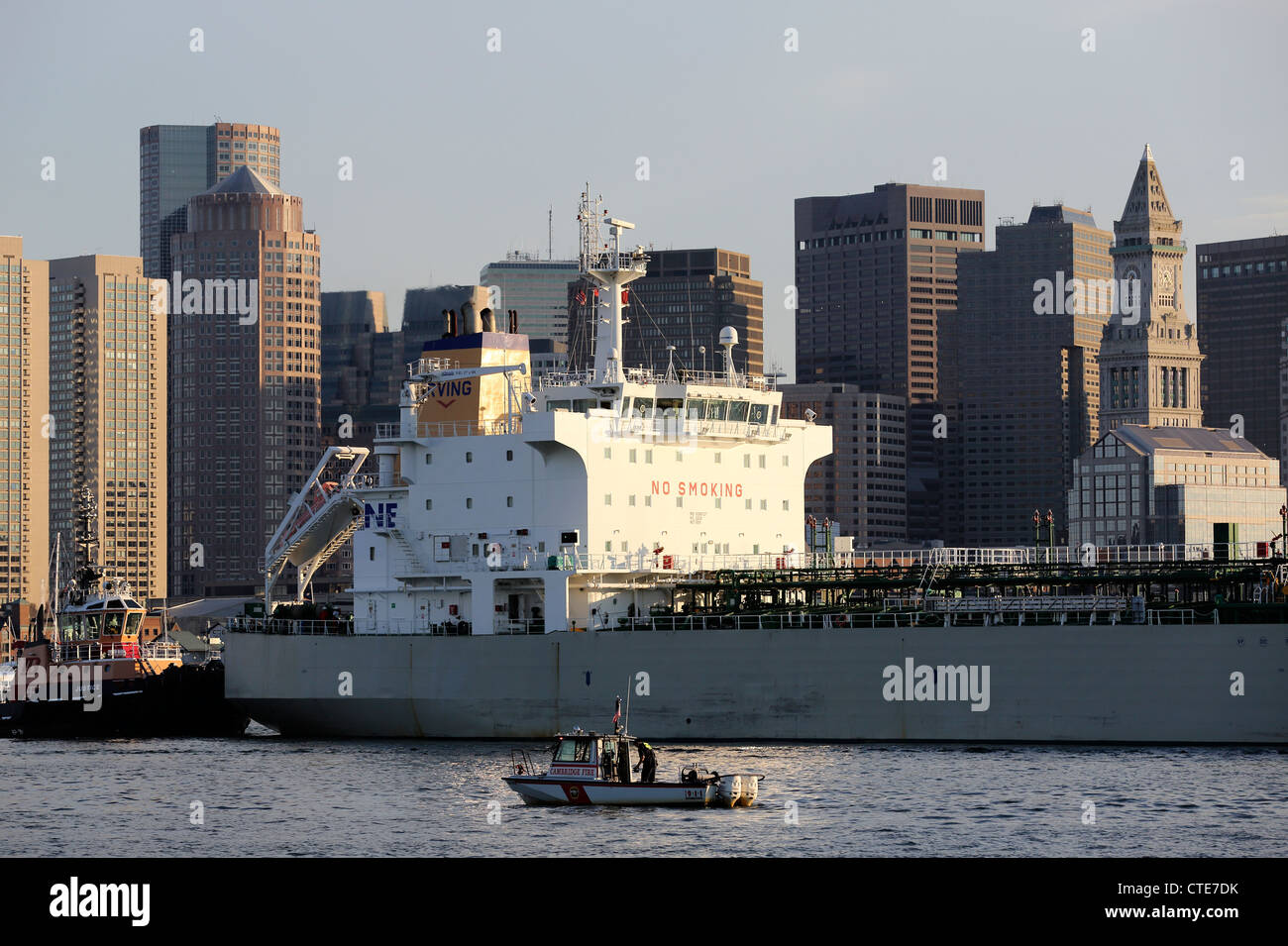 An oil tanker on Boston Harbor moves past the downtown Boston skyline ...