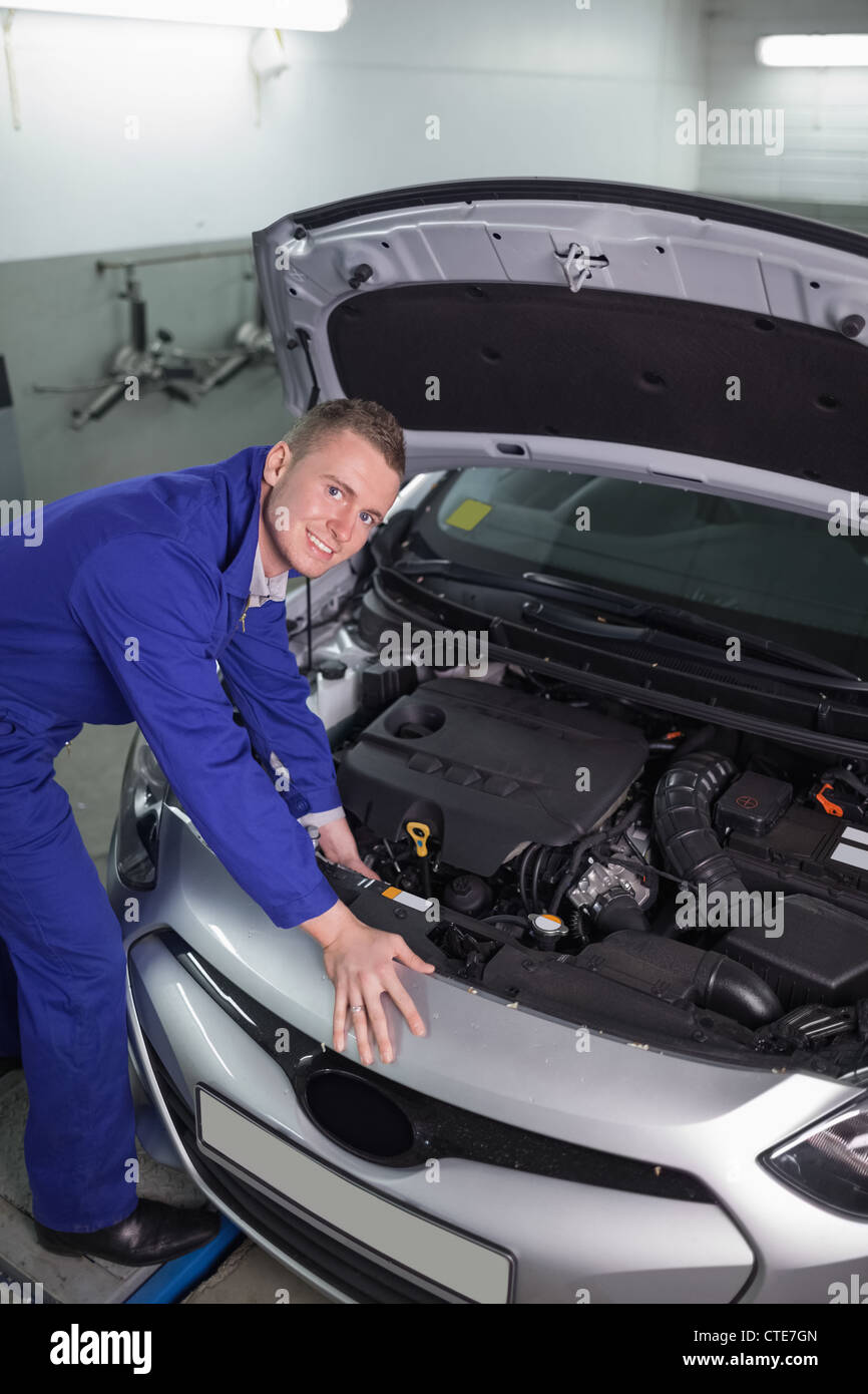 Mechanic repairing a car engine Stock Photo - Alamy