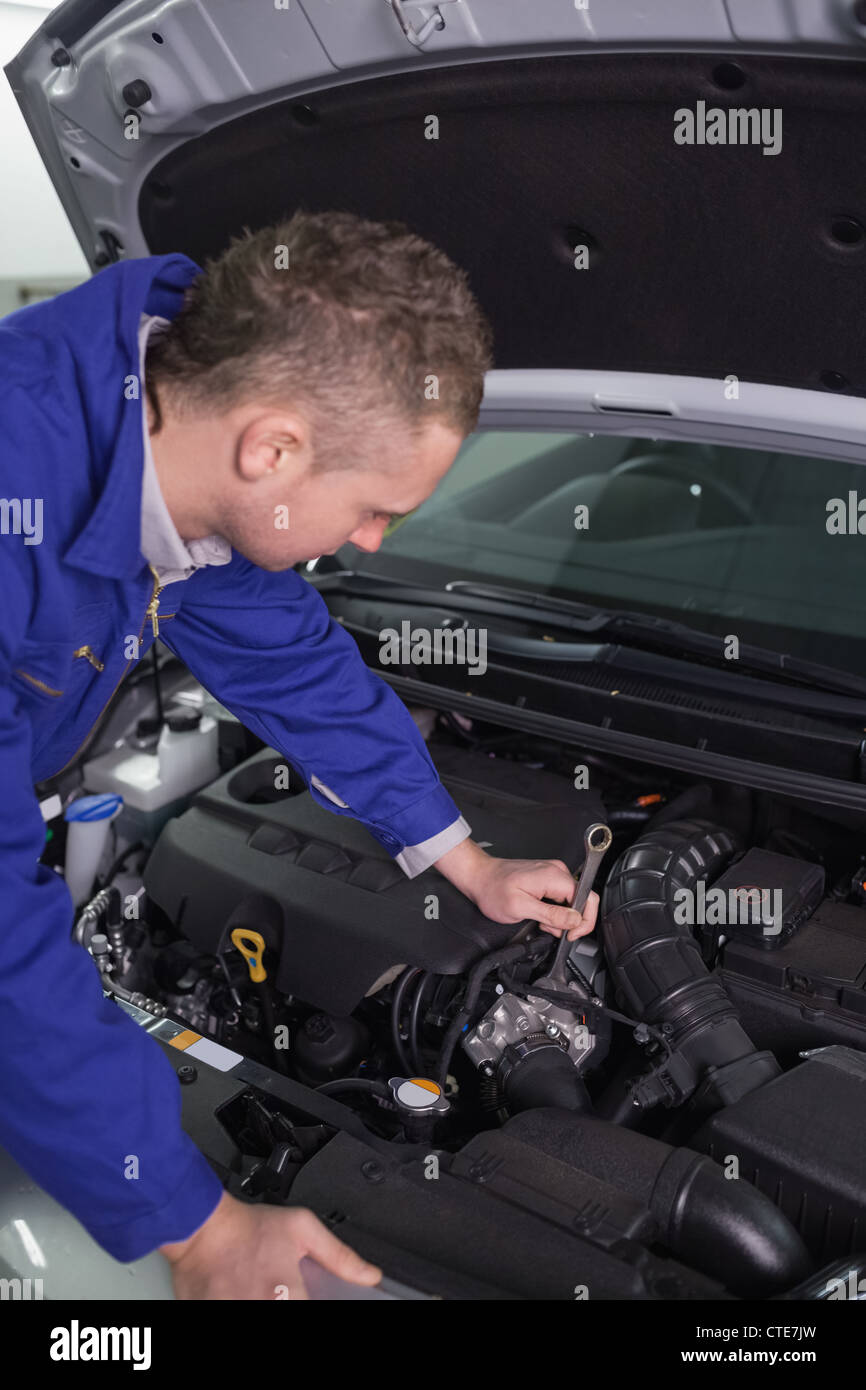 Mechanic repairing an engine with a spanner Stock Photo - Alamy