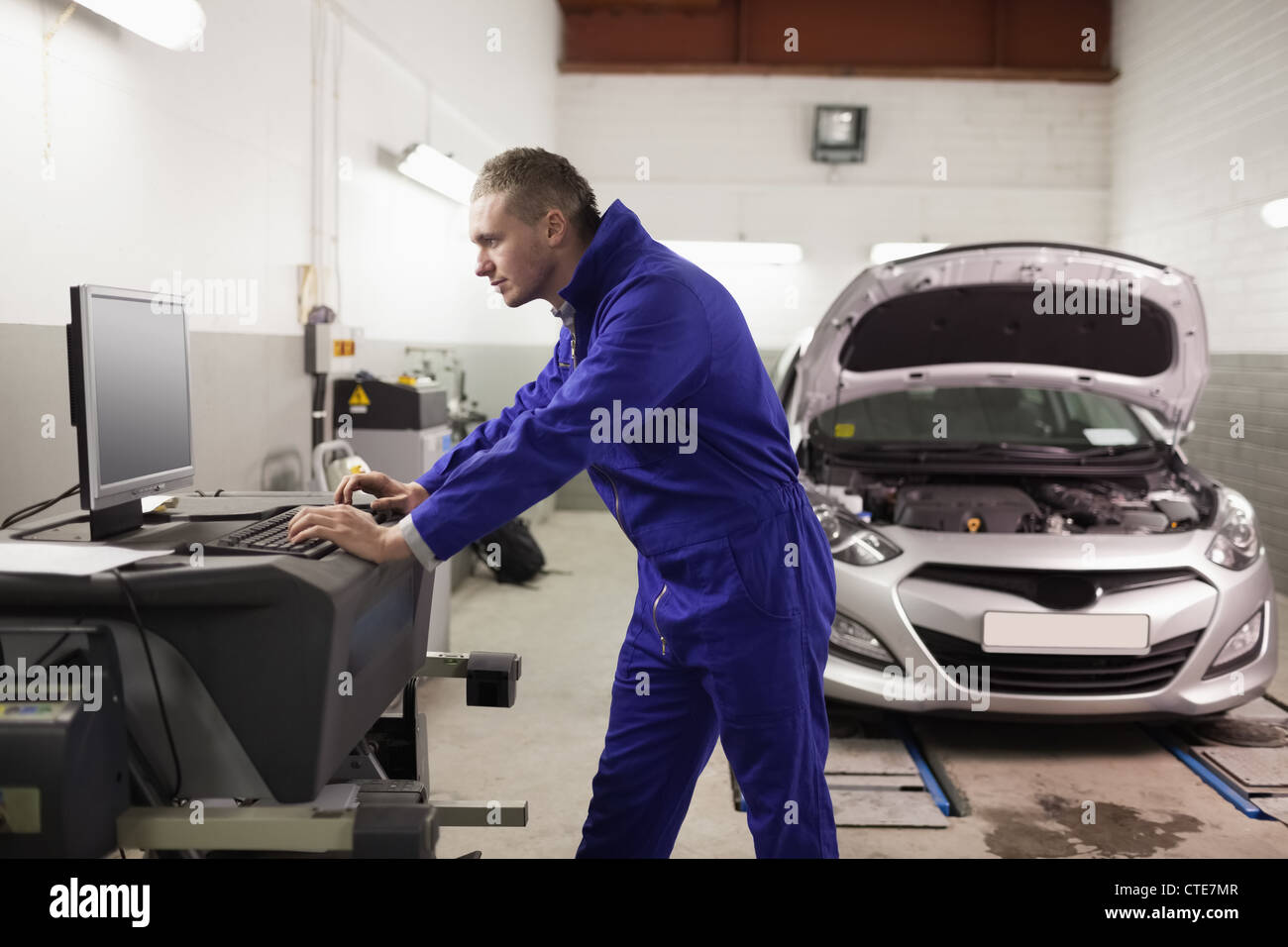 Mechanic using a computer Stock Photo - Alamy
