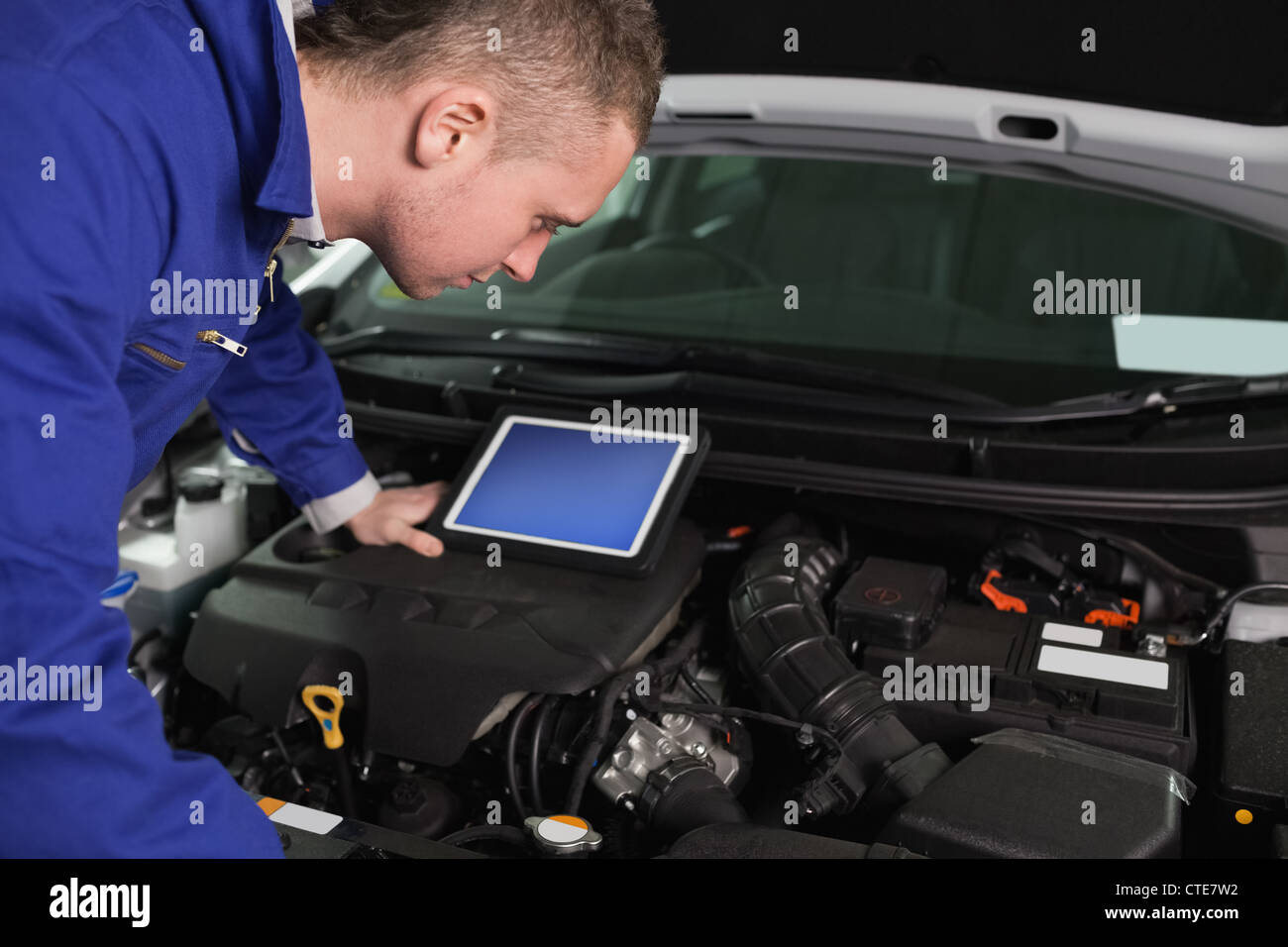 Mechanic checking an engine Stock Photo - Alamy