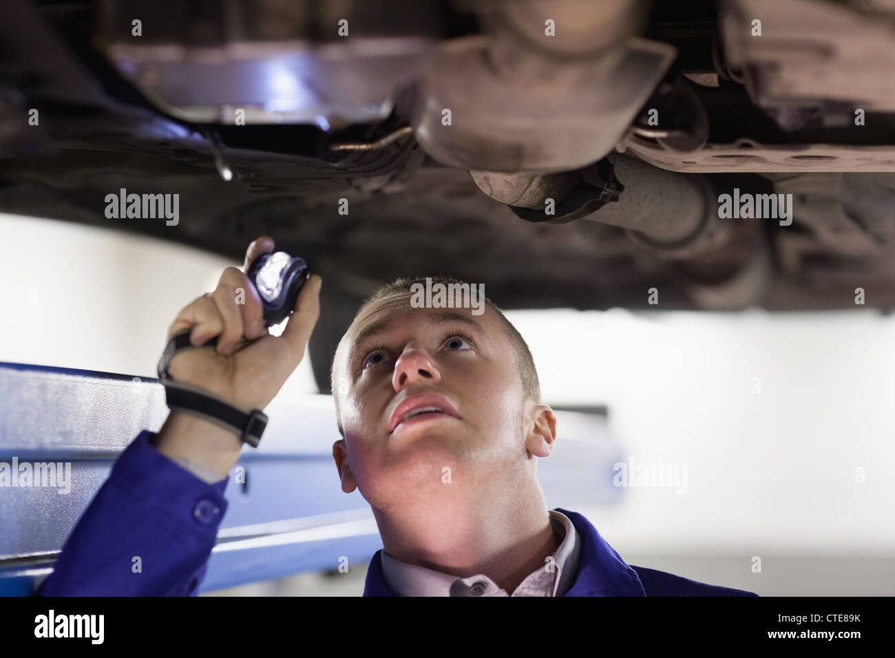 Mechanic holding a flashlight Stock Photo - Alamy