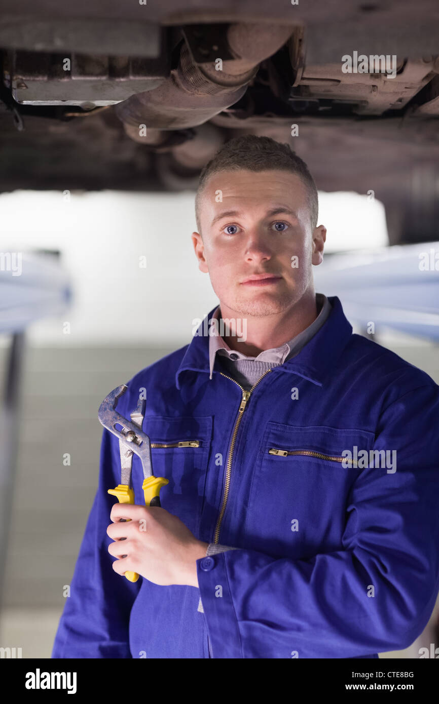 Mechanic holding an adjustable pliers Stock Photo - Alamy