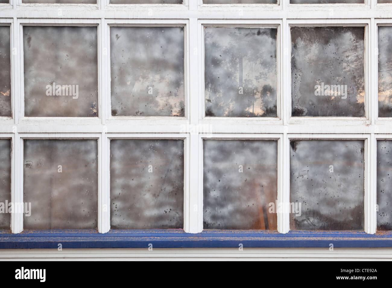 old grunge multi panel window with street reflection Stock Photo - Alamy