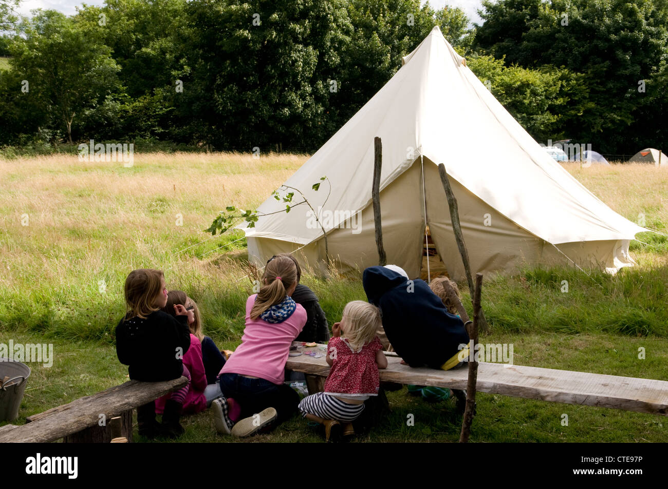 Children sitting and playing in a campsite Stock Photo - Alamy