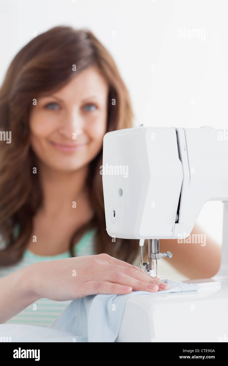 Woman using a sewing machine Stock Photo - Alamy