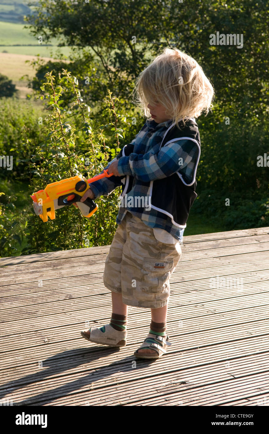 Boy playing plastic toy gun hi-res stock photography and images - Alamy