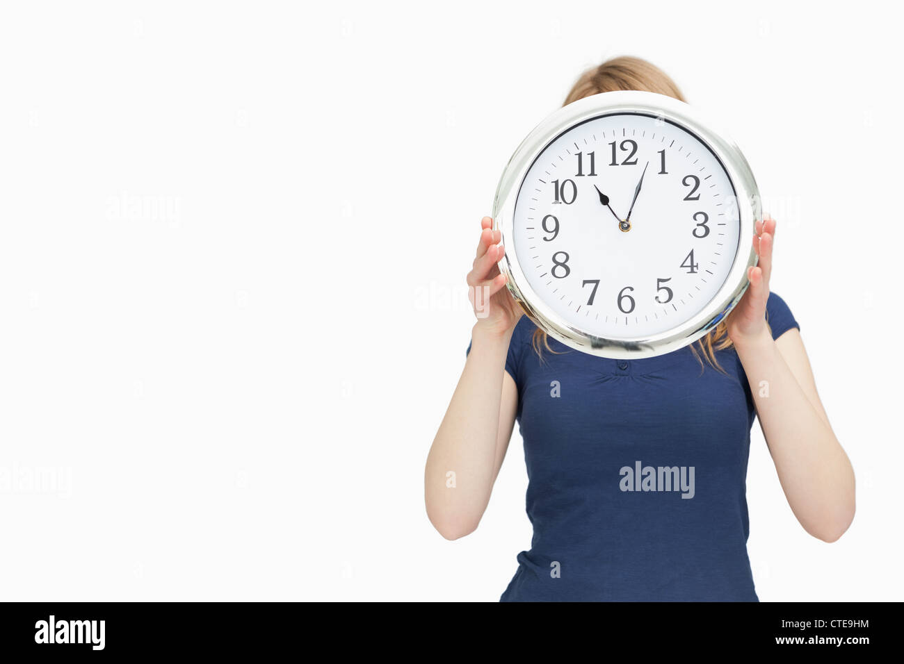 Blonde woman holding a clock Stock Photo - Alamy
