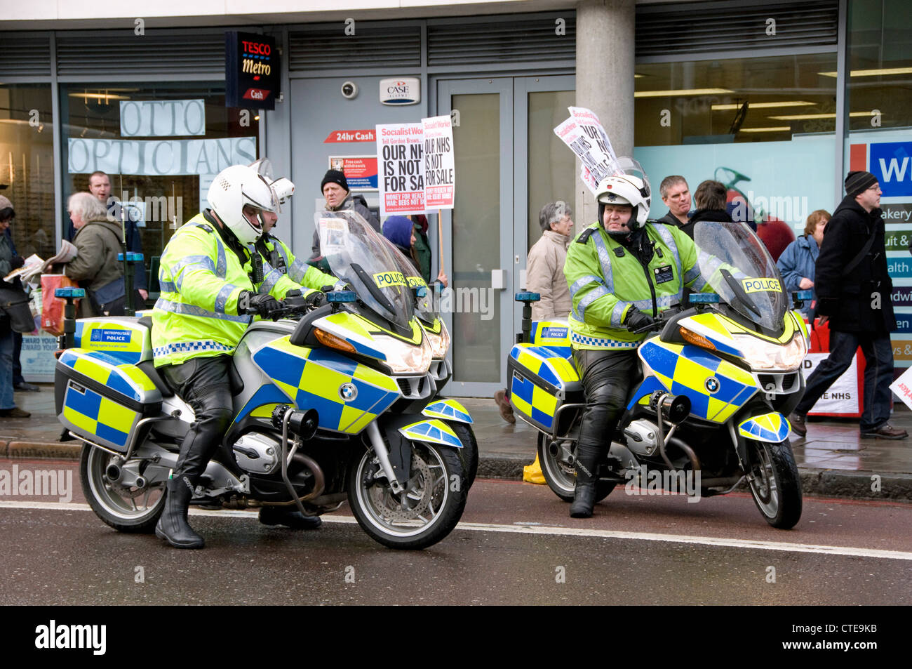 Three police officers on motorcycles at demonstration, Holloway Road ...