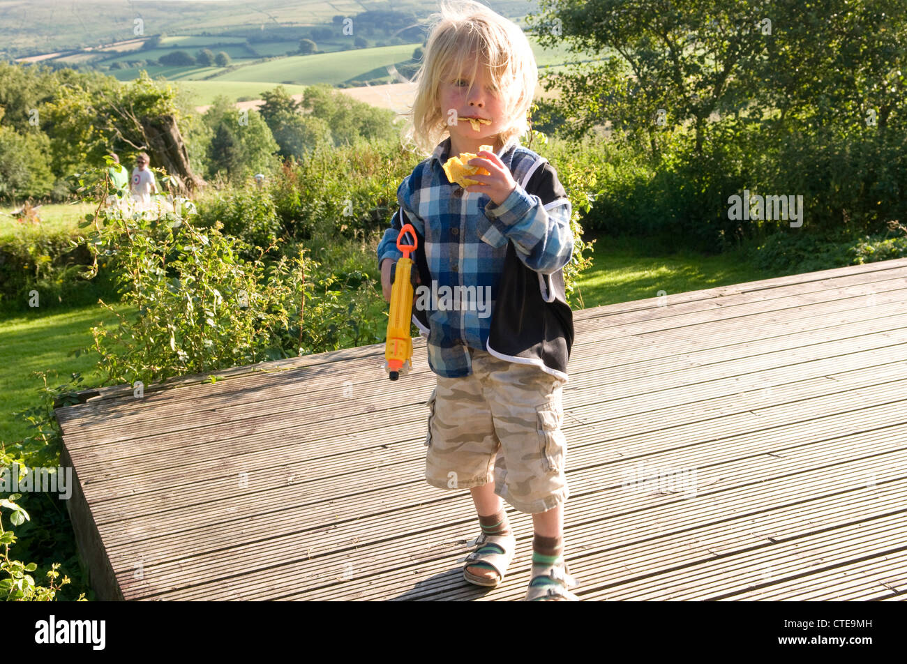 Little boy playing with a toy gun outside Stock Photo - Alamy