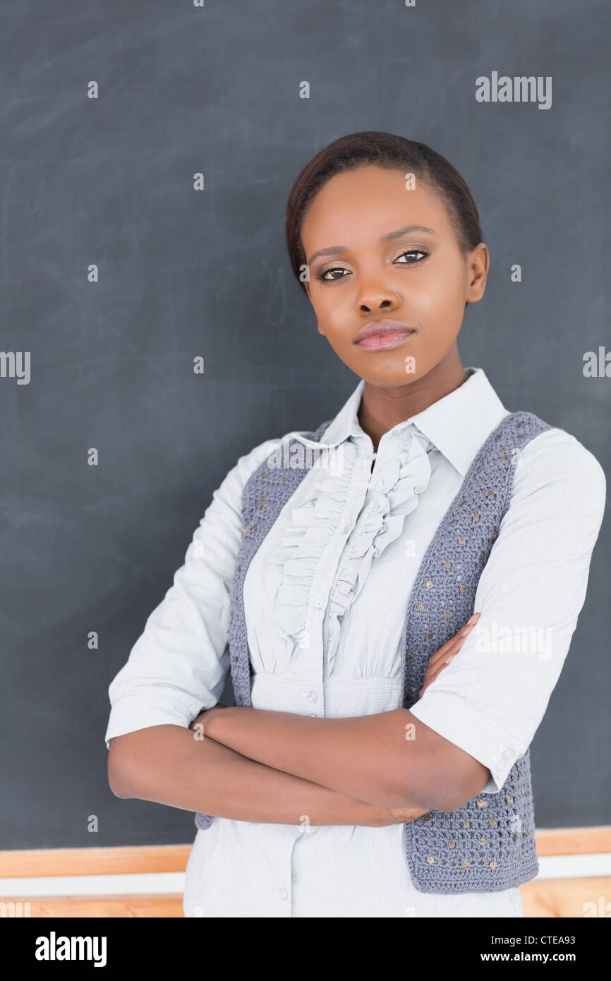Serious teacher looking at camera with arms crossed Stock Photo - Alamy