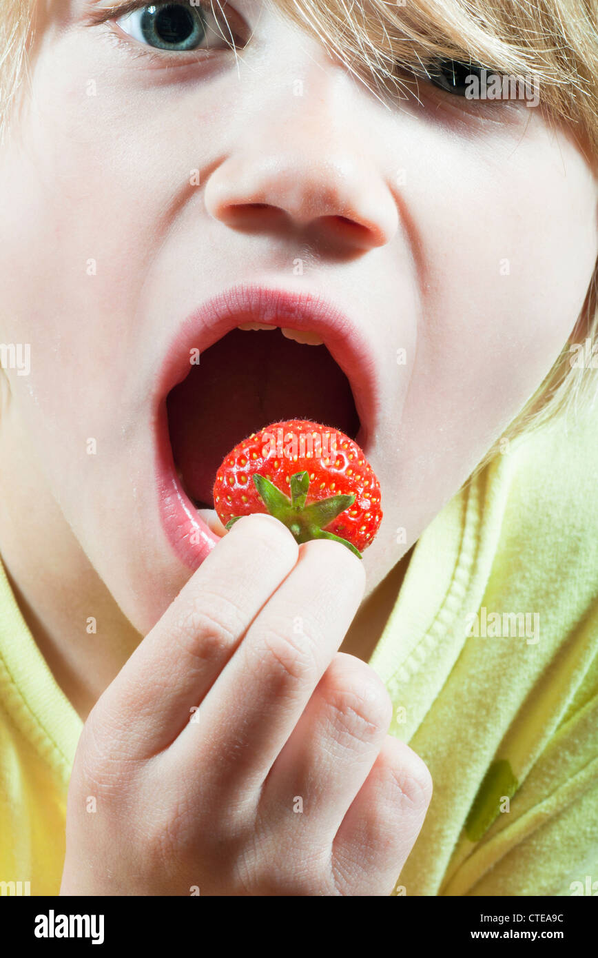 child eating strawberry Stock Photo - Alamy