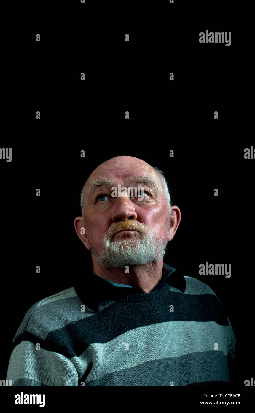 Senior man deep in thought Stock Photo - Alamy