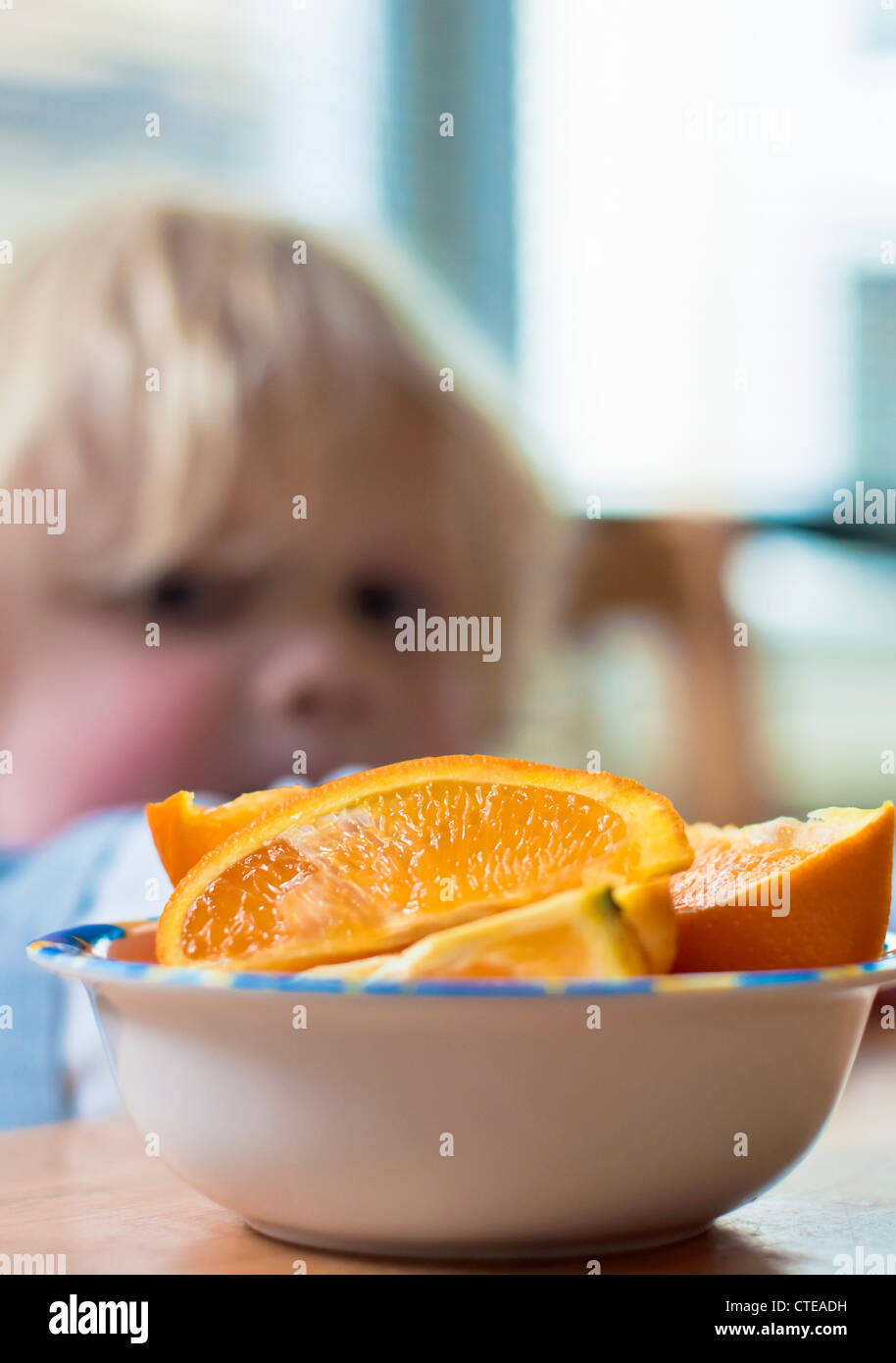 Child eating orange Stock Photo - Alamy