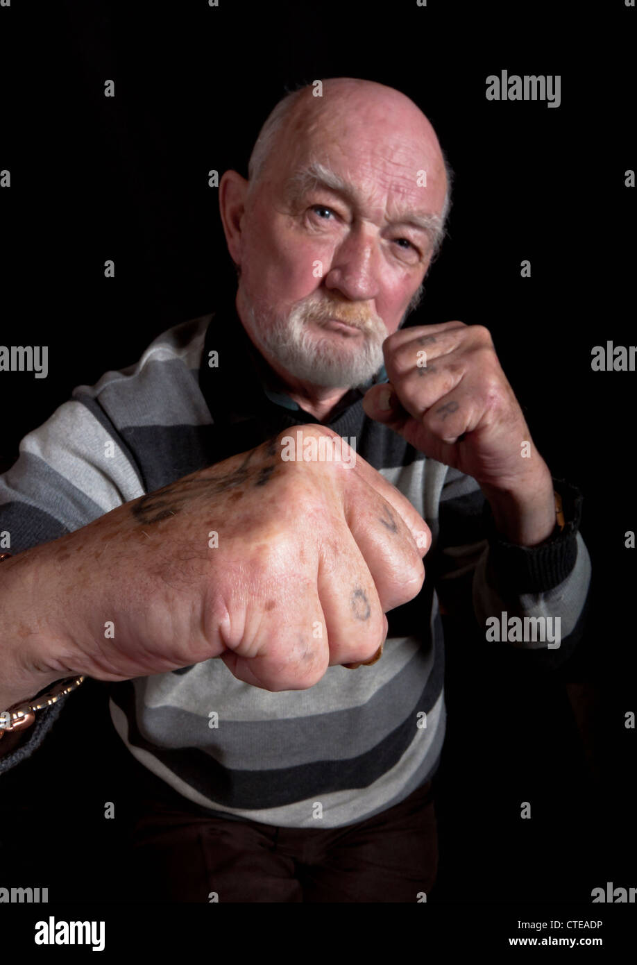Senior man punching Stock Photo - Alamy
