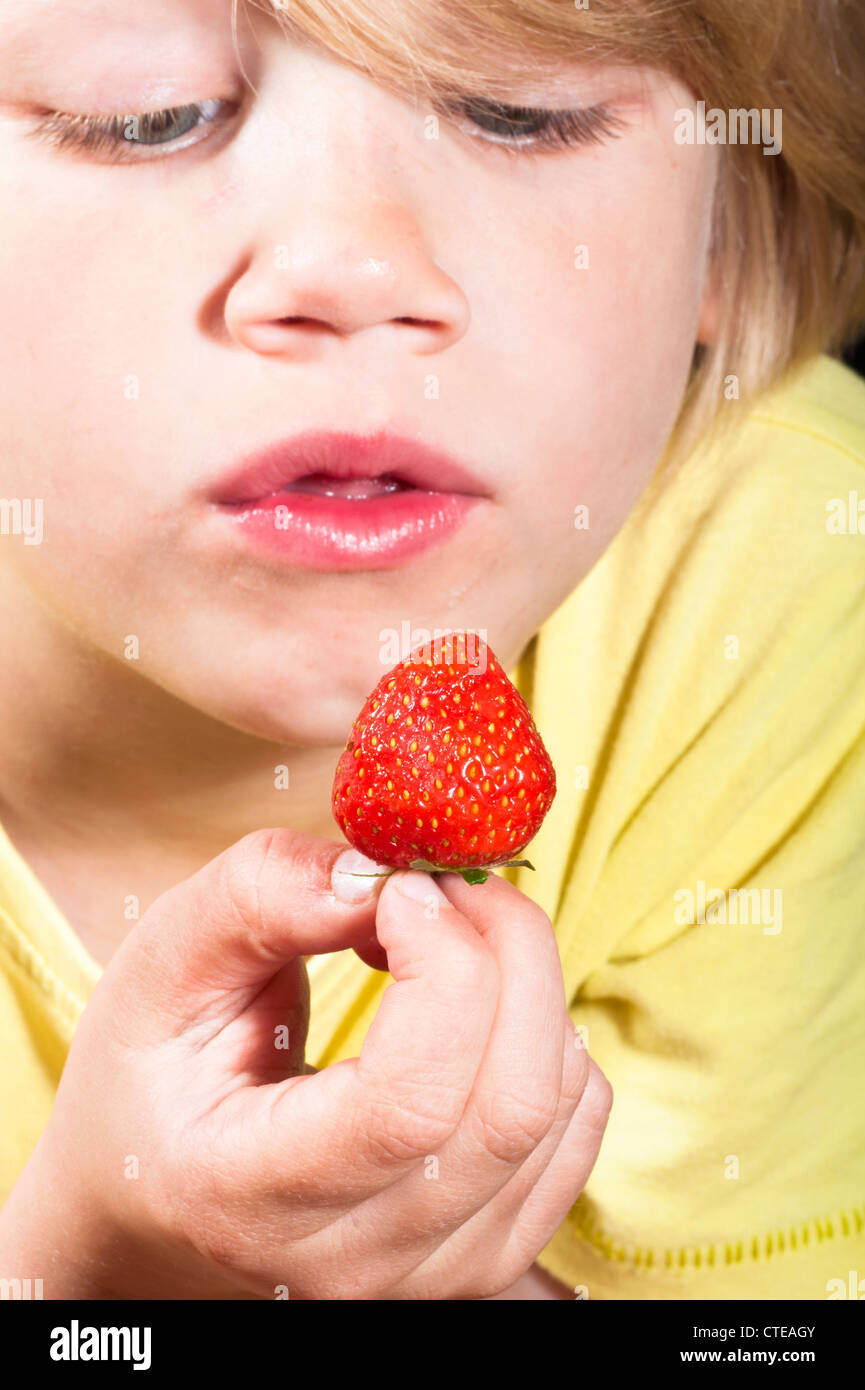 boy eating strawberry Stock Photo - Alamy