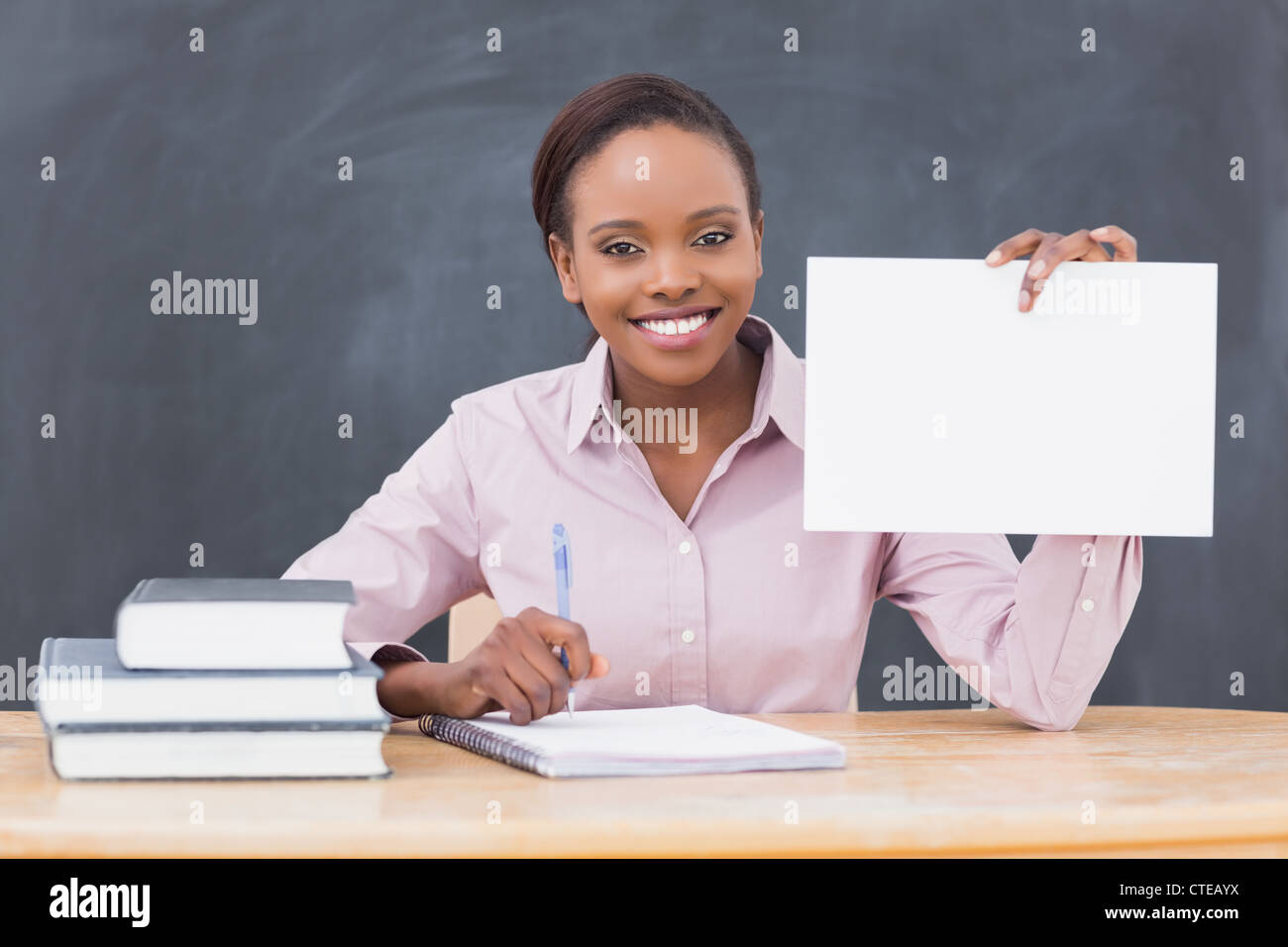 Black teacher holding a blank paper Stock Photo - Alamy