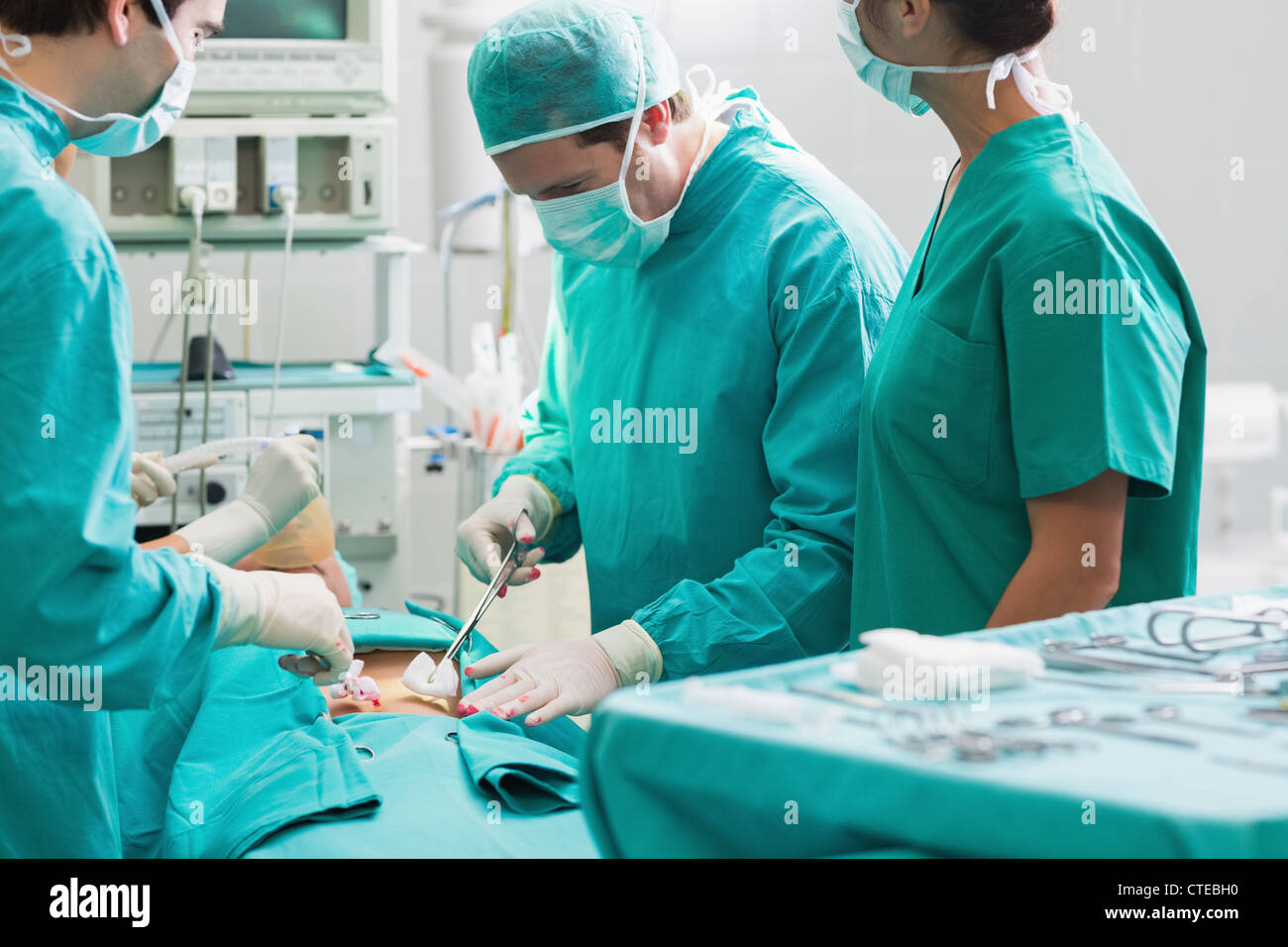 Confident surgeon operating a patient in an operating theater Stock ...