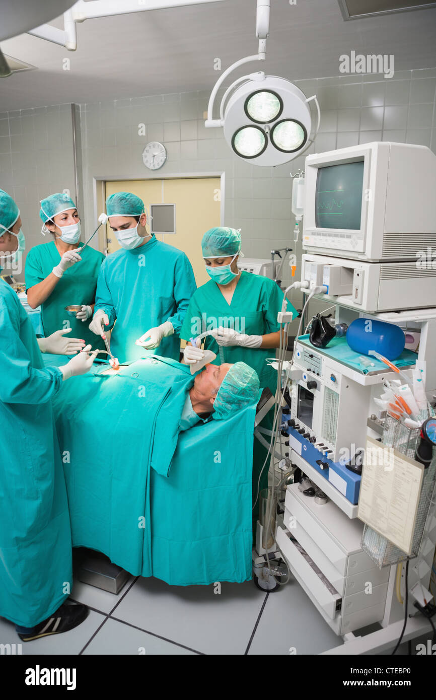 Patient lying on a medical bed undergoing an operation Stock Photo - Alamy