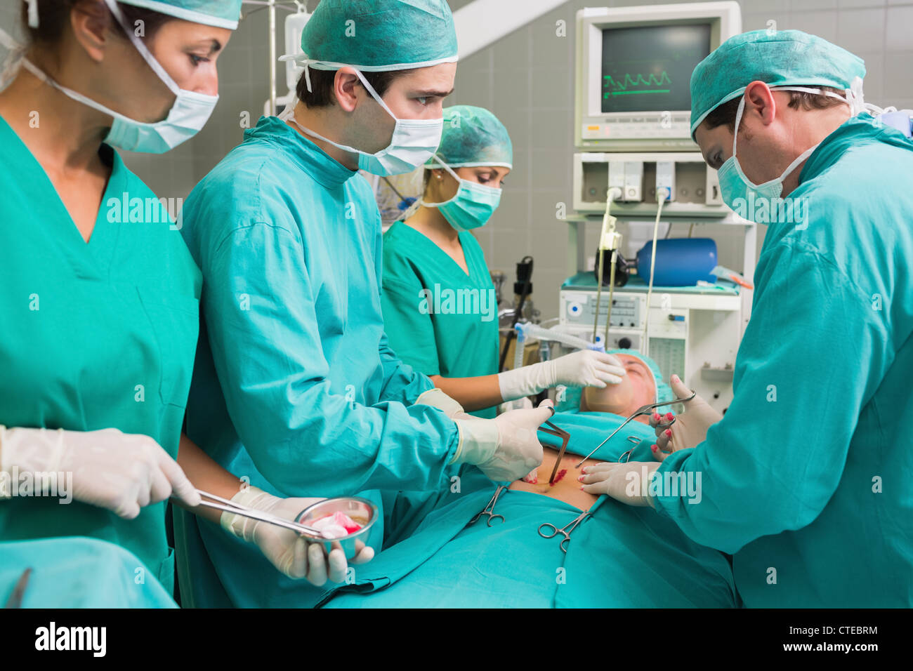 Surgeon operating with surgical tools Stock Photo - Alamy