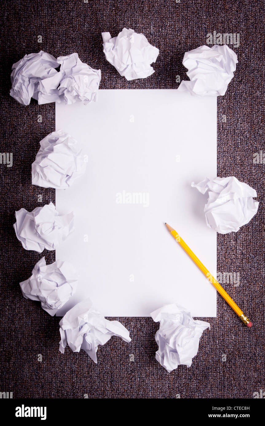 Crumpled and wrinkled white paper wads with fresh sheet of blank paper ...