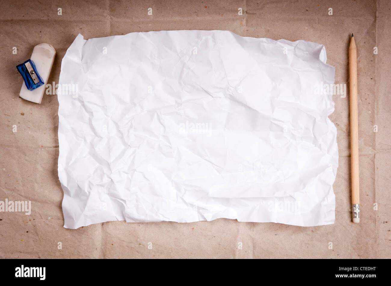 Writing concept - crumpled up paper wads with a sheet of white paper ...