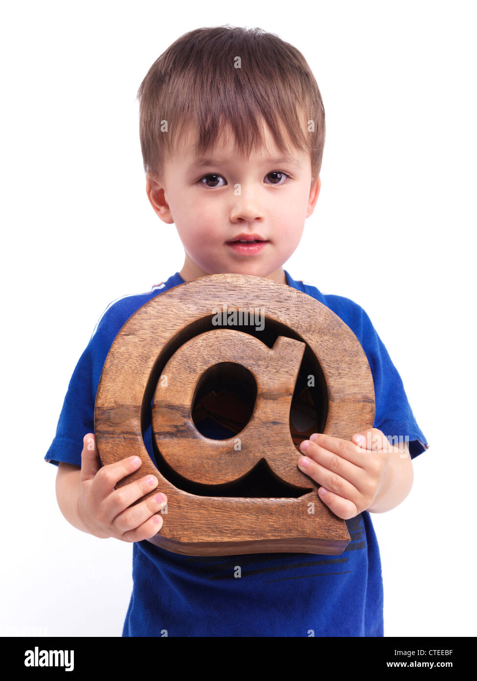 Two year old boy holding AT email symbol in his hands isolated on white ...