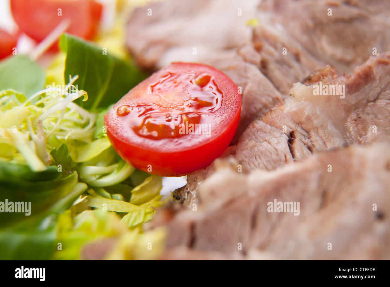 Tomatoes and sliced meat Stock Photo - Alamy