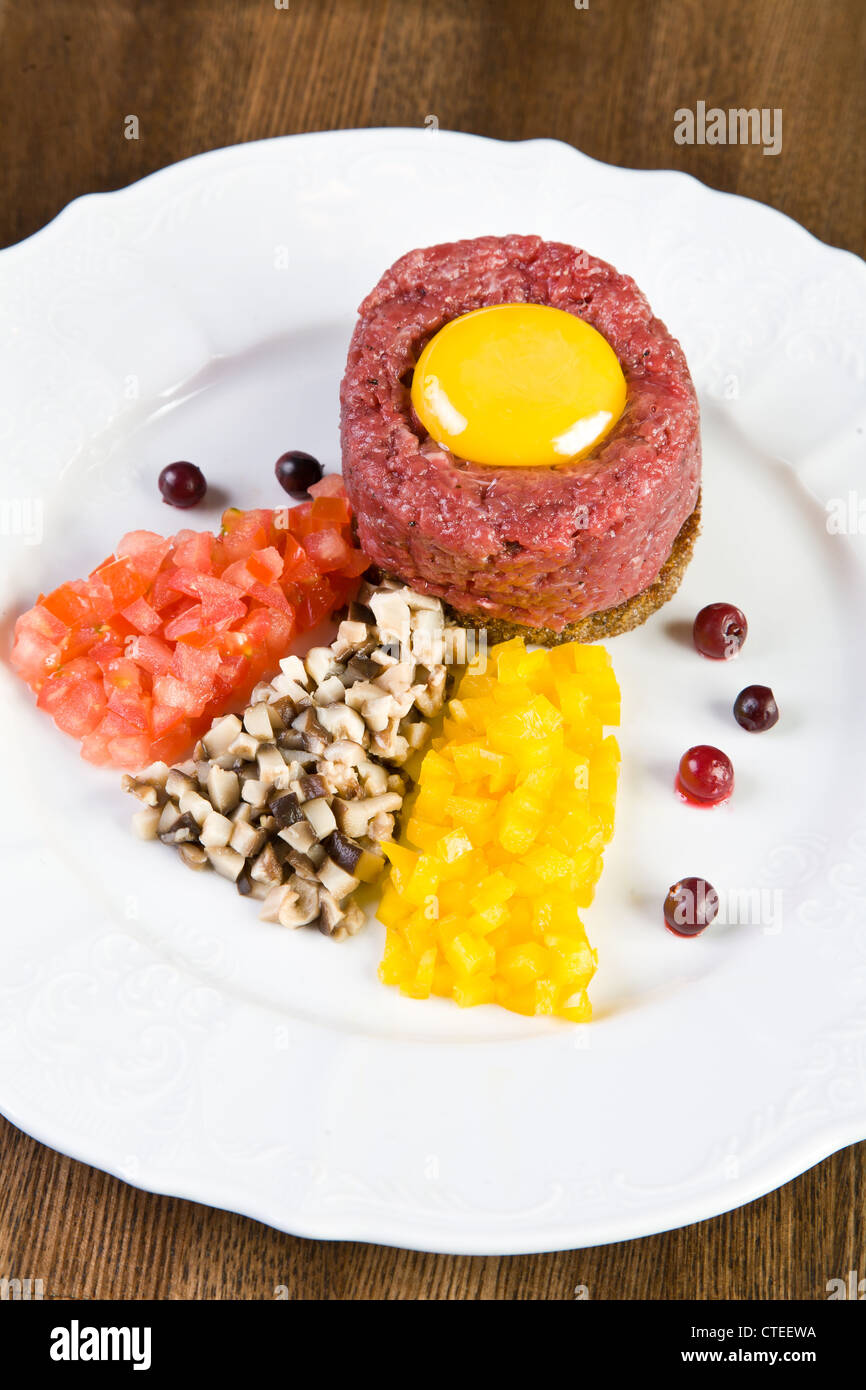 Raw chopped ostrich meat with vegetables Stock Photo - Alamy