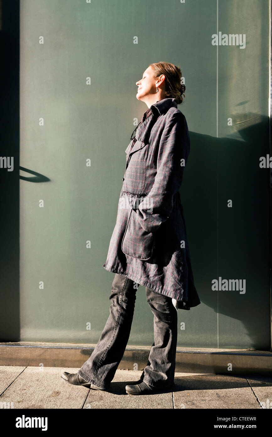 Woman standing in the sun shine Stock Photo - Alamy
