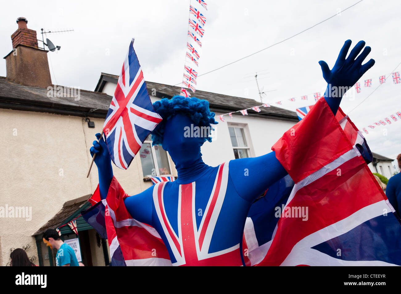 Proud Briton wearing Union Jack costume and waving the flag during a ...