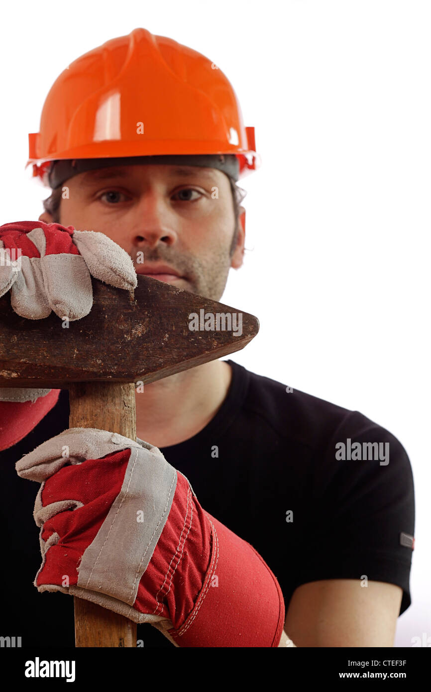 Construction worker with a big hammer isolated on a white background ...