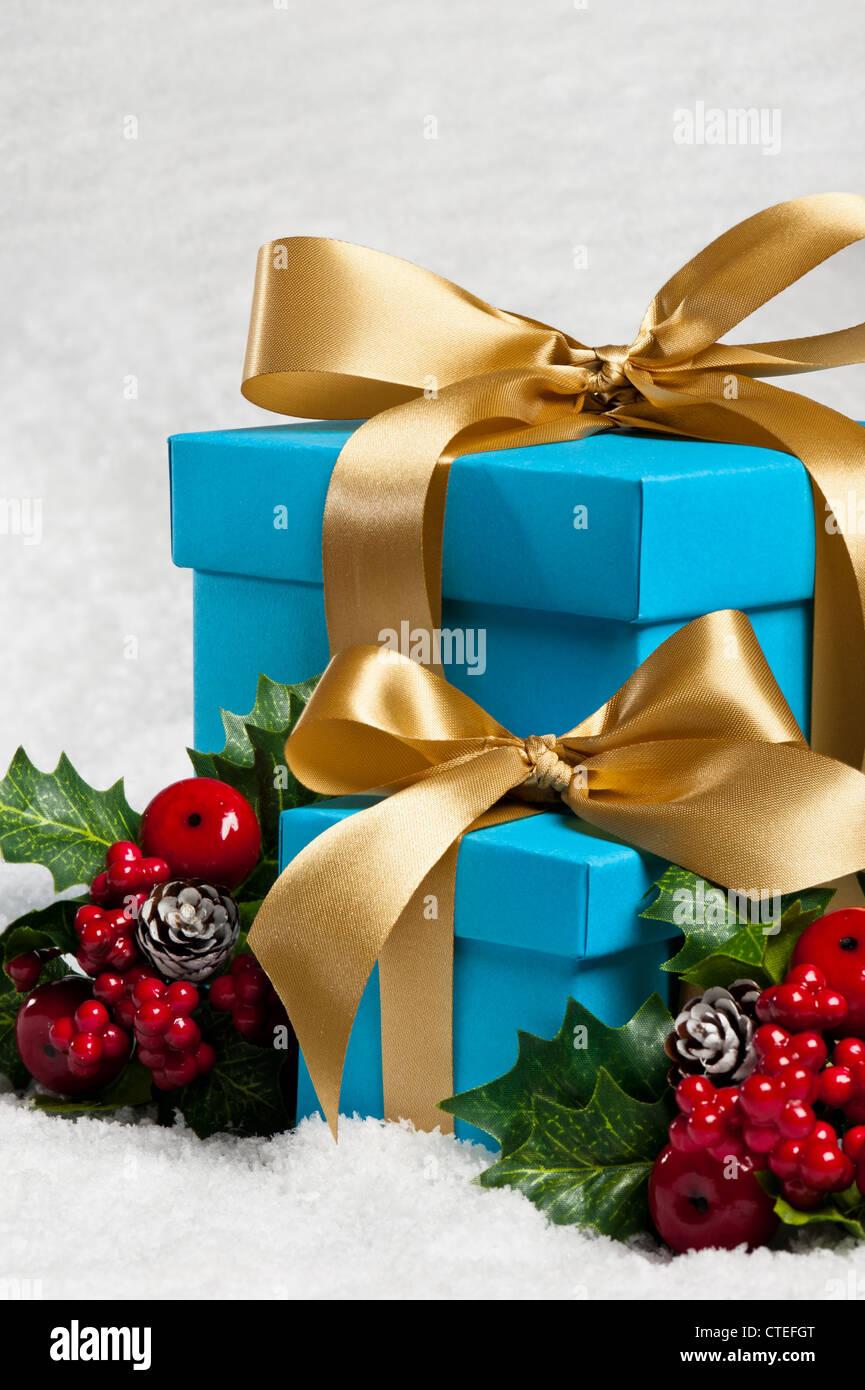 Blue present with gold ribbon and Christmas decoration Stock Photo - Alamy