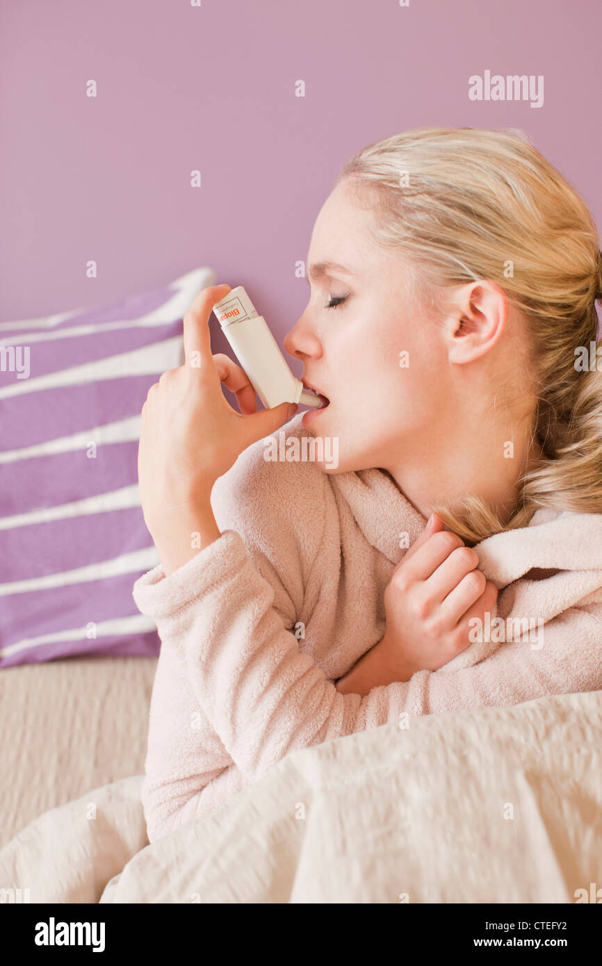 Woman using inhaler Stock Photo - Alamy