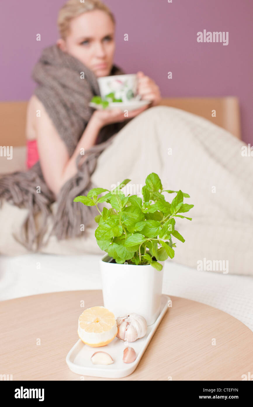 Sick woman drinking herbal tea Stock Photo - Alamy