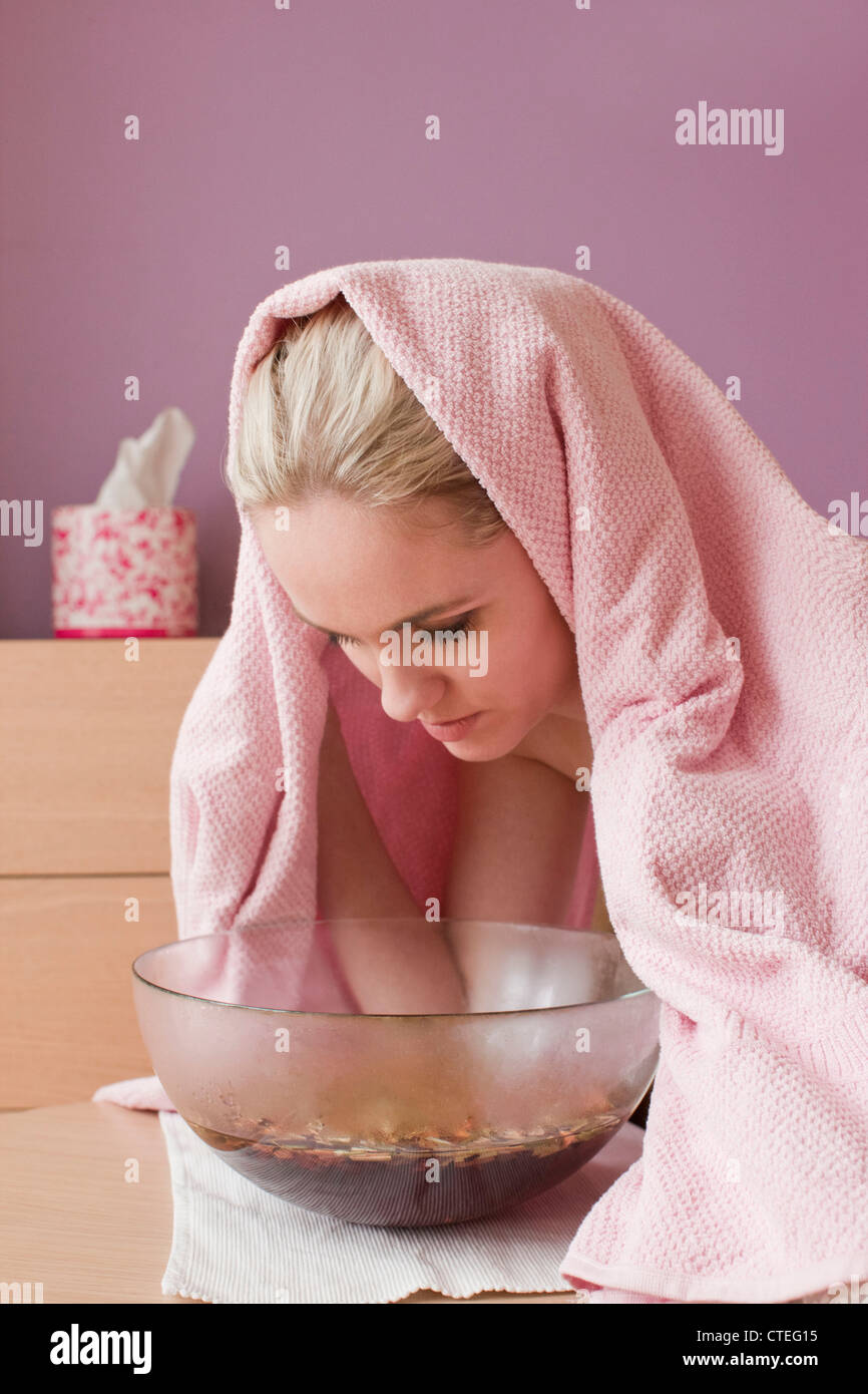 Young woman inhaling Stock Photo - Alamy
