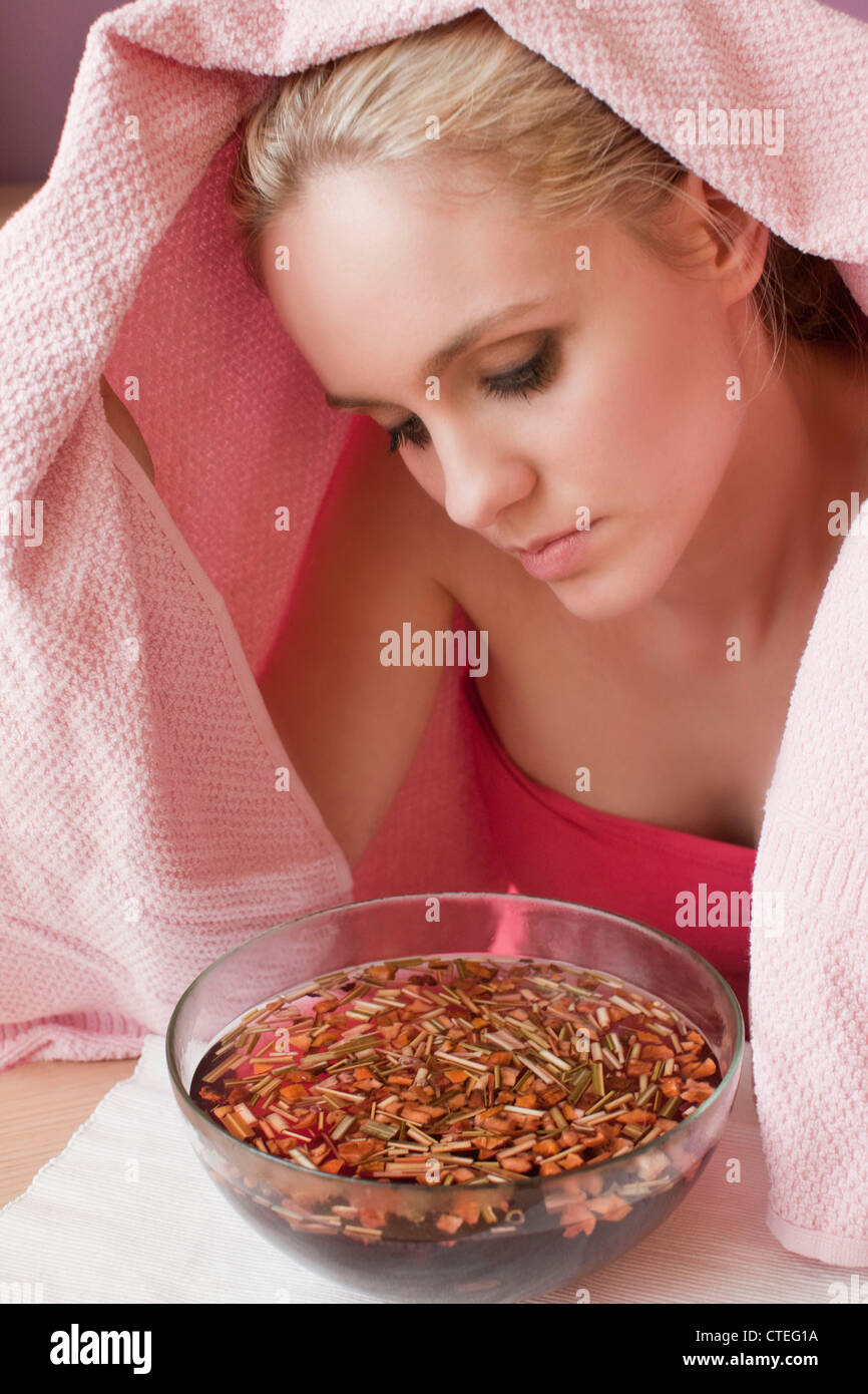 Young woman inhaling Stock Photo - Alamy