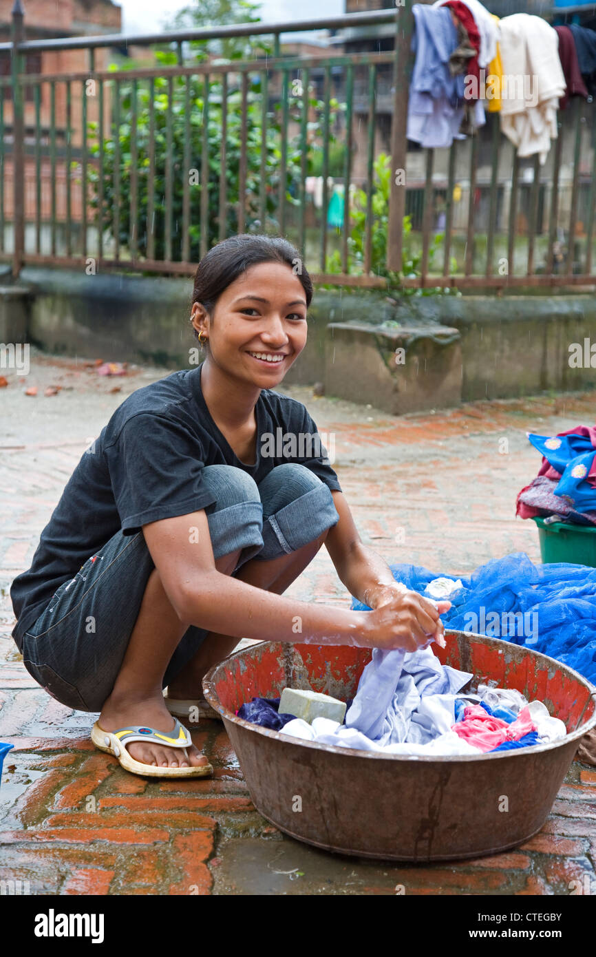 Native teenager washing clothes in the town of Bhaktapur near Kathmandu ...