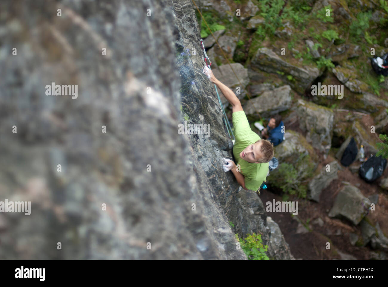 Climber climbing a rick wall Stock Photo - Alamy