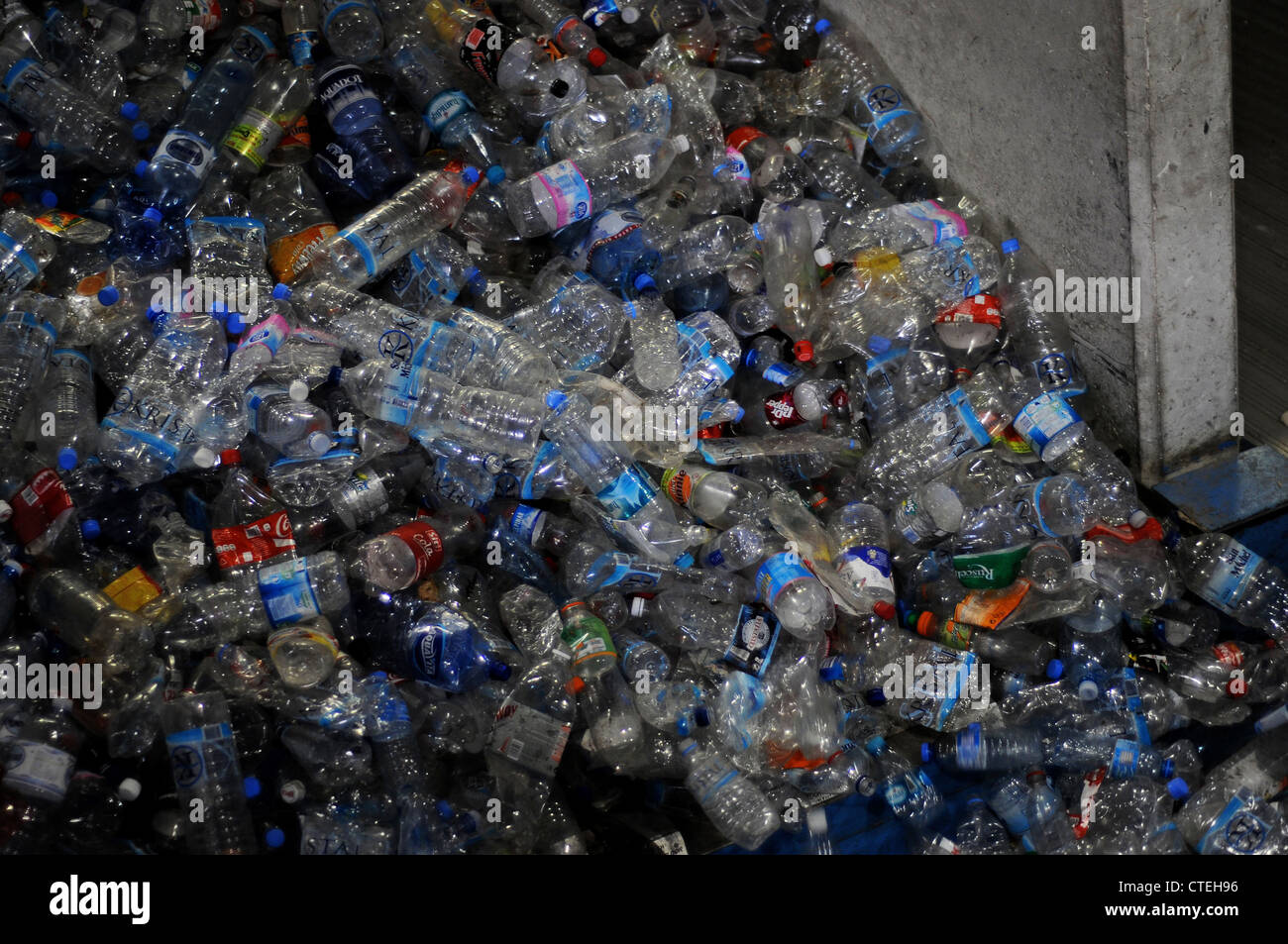 Used clear and colour plastic bottles ready to be recycled in a ...