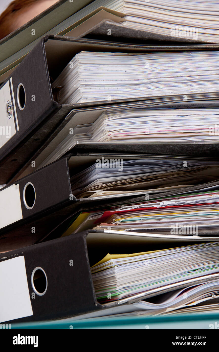 business woman in office looks at unbelievable folder stack isolated on ...