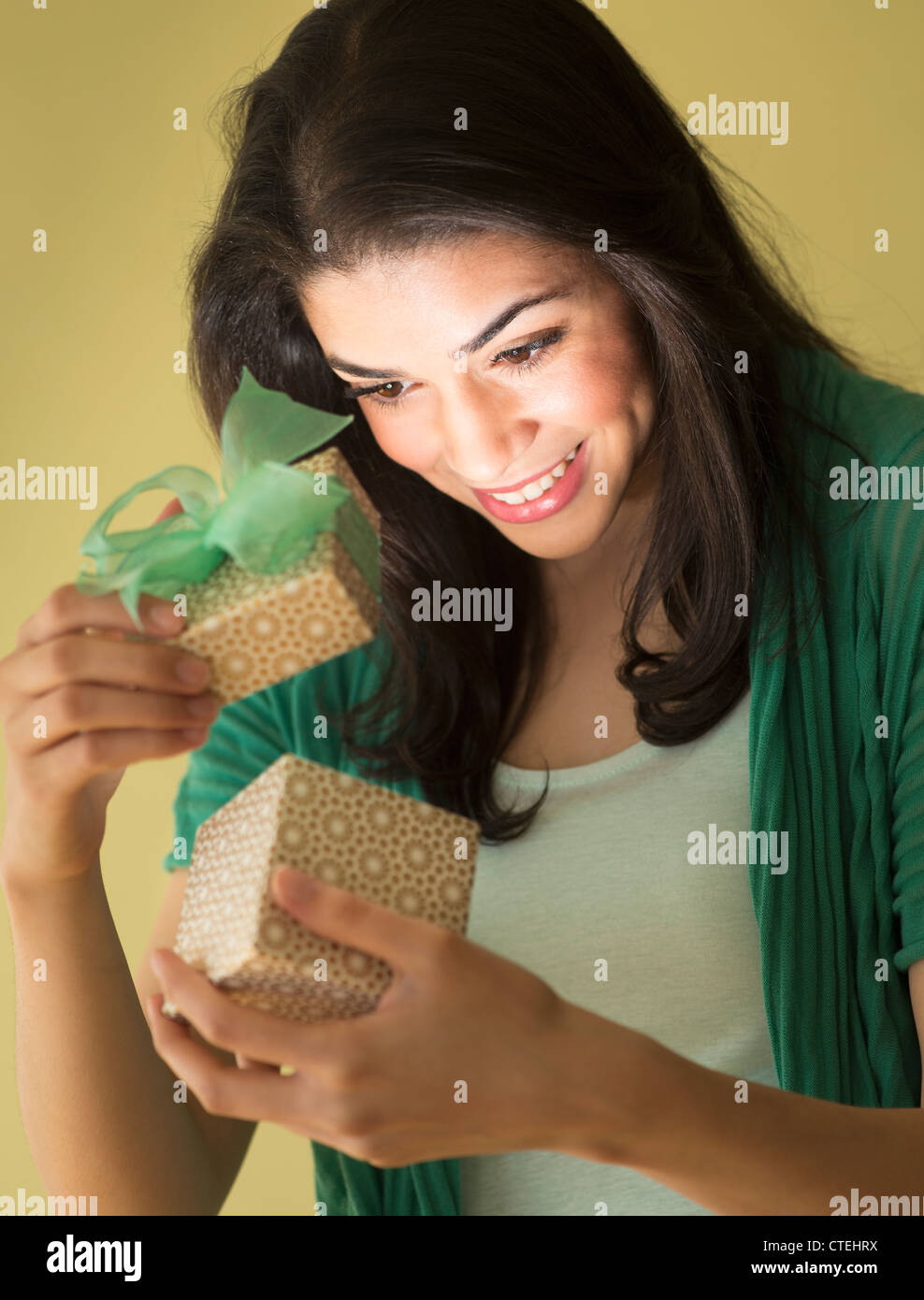 Young woman opening gift box Stock Photo - Alamy