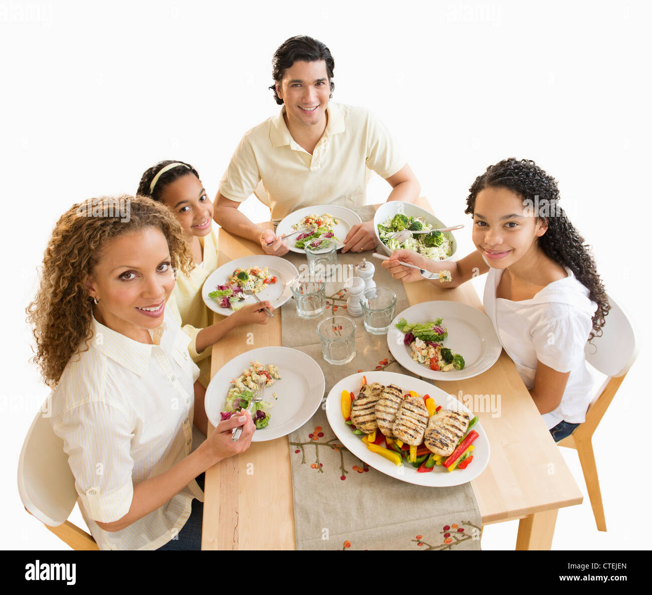 Portrait of parents with daughters (10-13) eating dinner Stock Photo ...