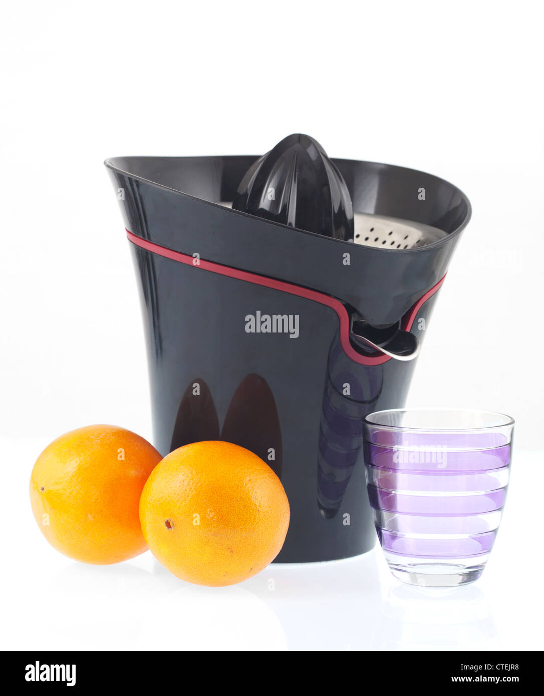 Glass of orange juice with squeezer Cut Out Stock Images & Pictures - Alamy