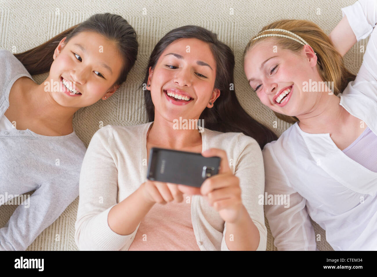Teenage friends lying on floor hi-res stock photography and images - Alamy