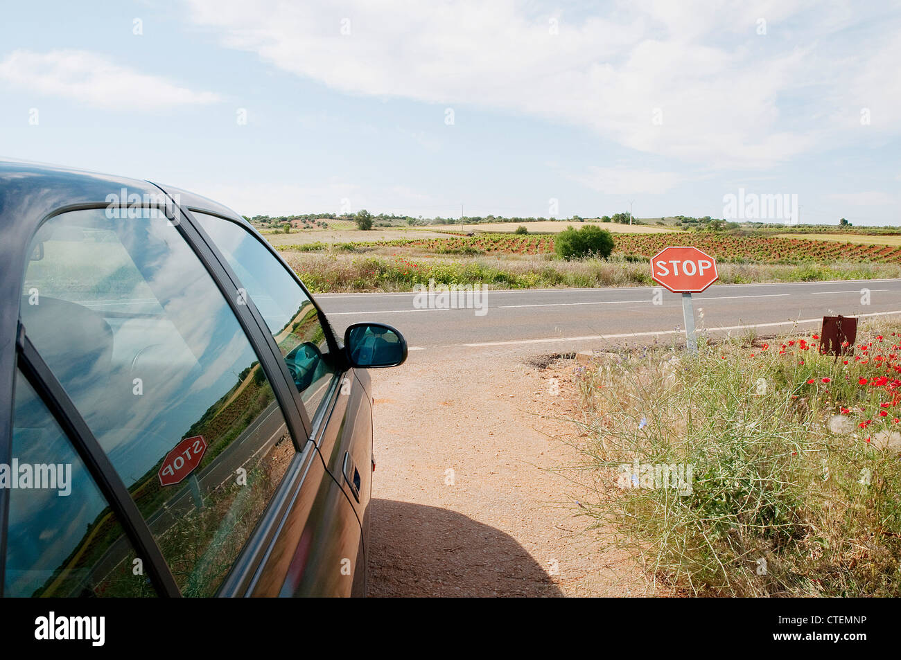 Crossroads, car and stop sign Stock Photo - Alamy