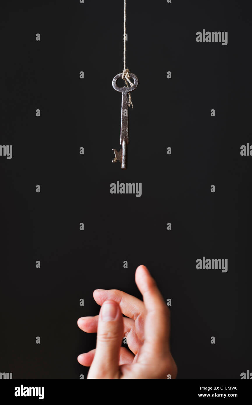 Hand reaching for key Stock Photo - Alamy