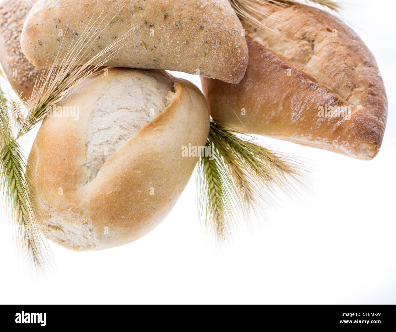 Three buns with wheat isolated on white background Stock Photo - Alamy