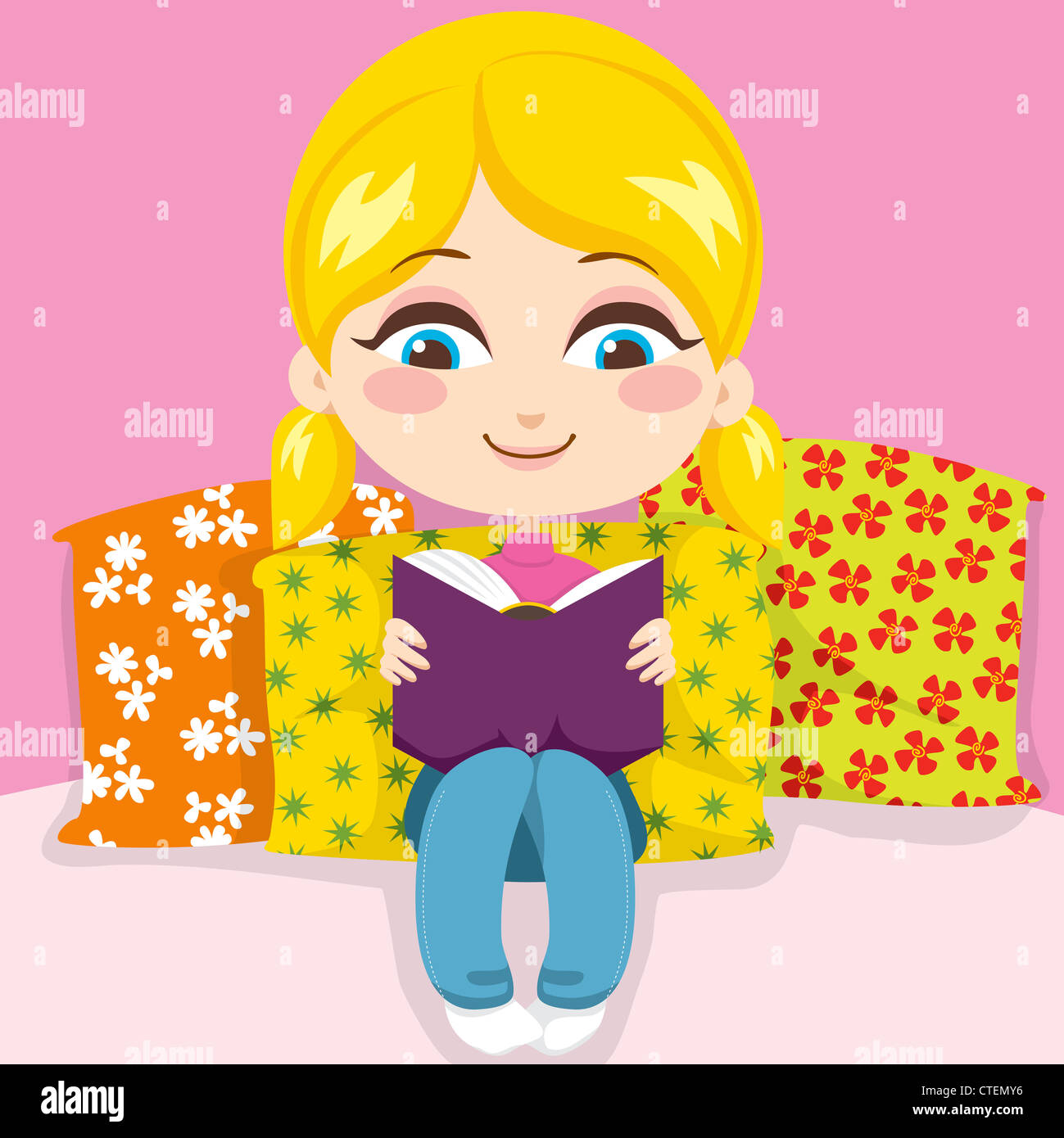 Cute little blond girl smiling reading a very interesting book sitting ...