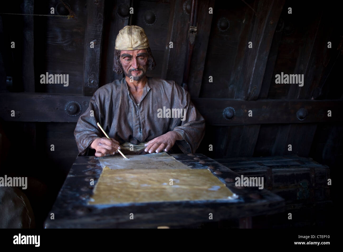 A sculpture of a sailor writing displayed in a reproduction of the ...